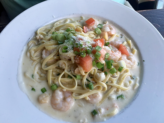 Fettuccine swimming in a creamy sea of delicate flavors, where plump shrimp and fresh tomatoes play starring roles in this pasta performance.