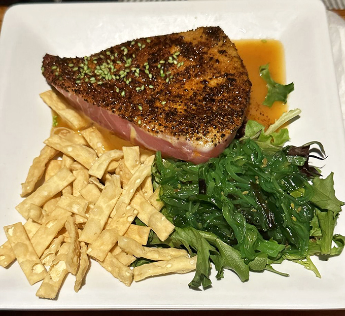 Seared tuna that's beach-vacation pink in the middle, served with seaweed salad that tastes like the ocean decided to throw a party on your plate.