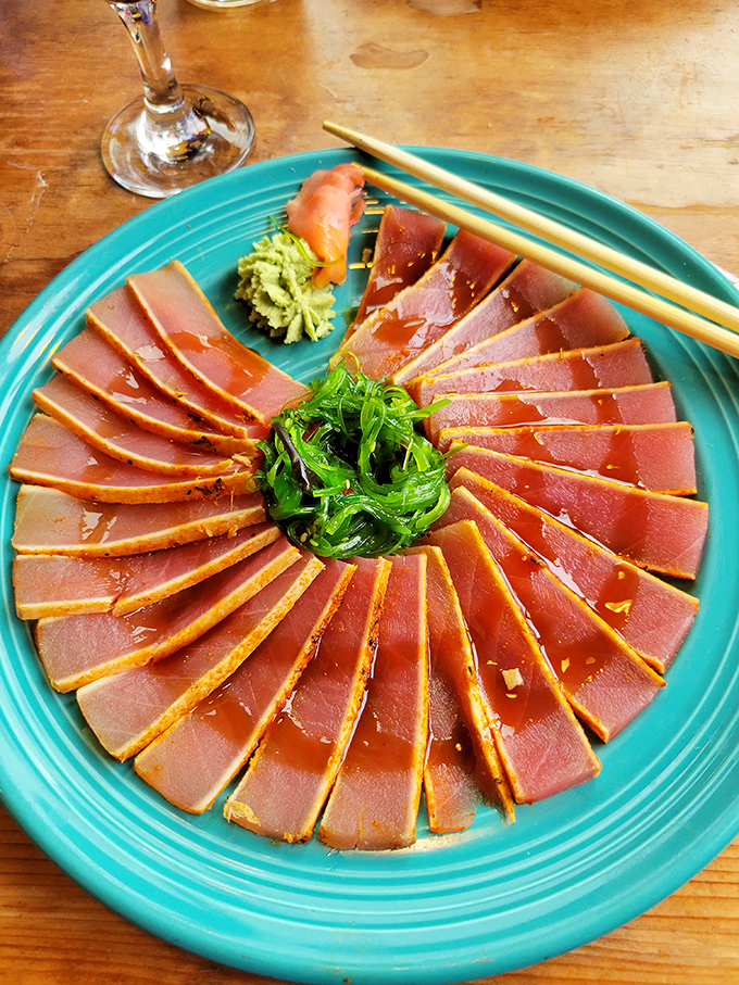 The seared ahi tuna, arranged like a sunset on turquoise waters, delivers that perfect balance of raw sophistication and primal satisfaction.