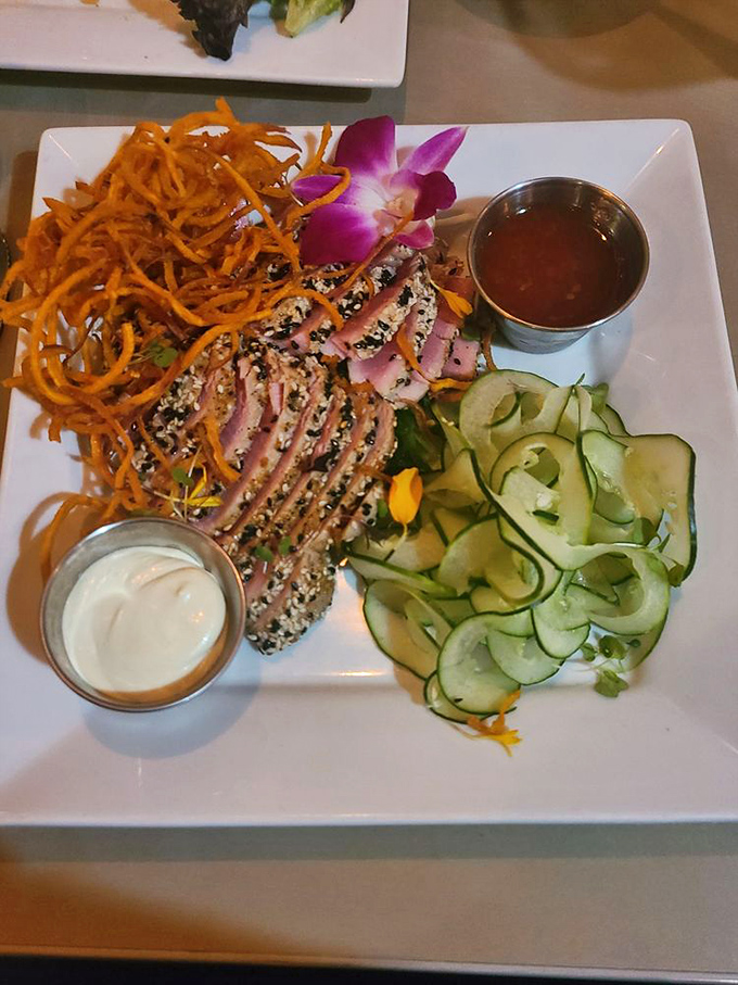 Surf meets turf in this culinary tango&mdash;seared tuna and what appears to be a crab cake performing a delicious duet with a spicy sauce playing conductor.