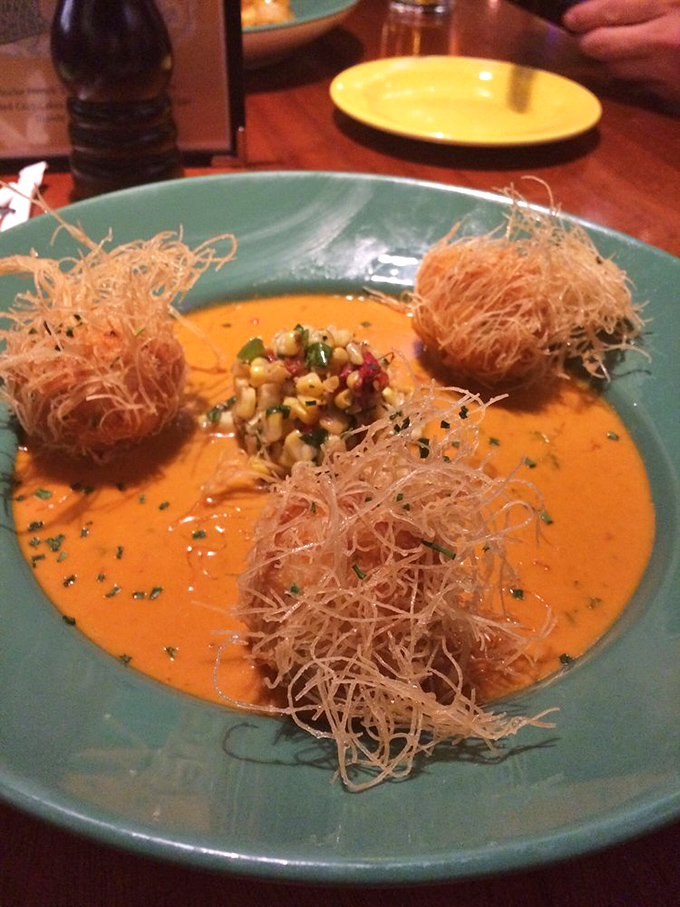 These aren't your average fritters &ndash; they're crispy orbs of seafood joy swimming in a sauce that deserves its own area code.