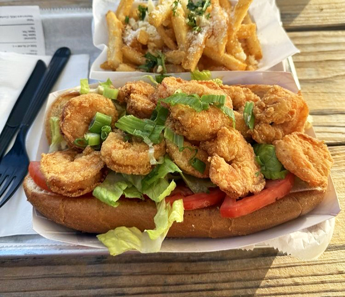 Shrimp Po' Boy perfection: crispy golden crustaceans piled high on fresh bread with all the fixings. This sandwich doesn't need a passport to transport you.