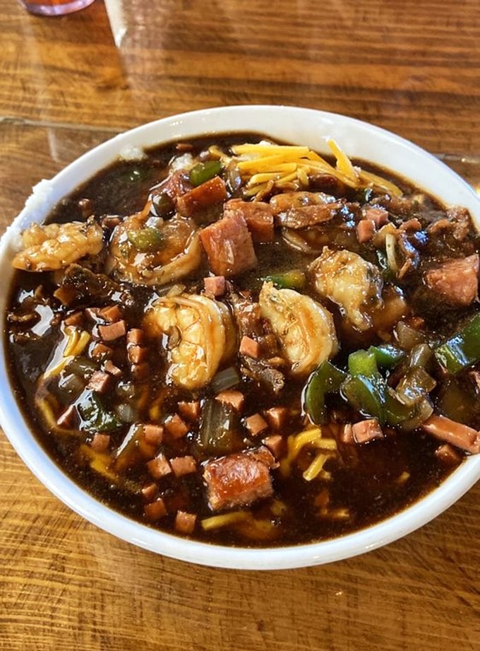 Swimming in creamy grits with bacon and sausage, these jumbo shrimp know how to make an entrance.