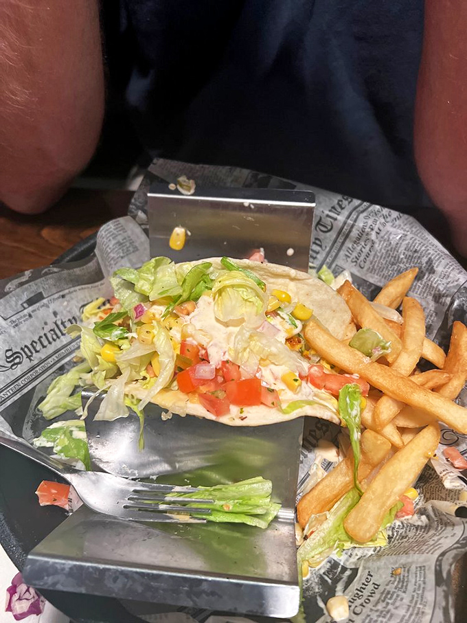 A taco that doesn't just sit on your plate&mdash;it performs. Fresh lettuce, bright tomatoes, and a tortilla that knows its supporting role perfectly.