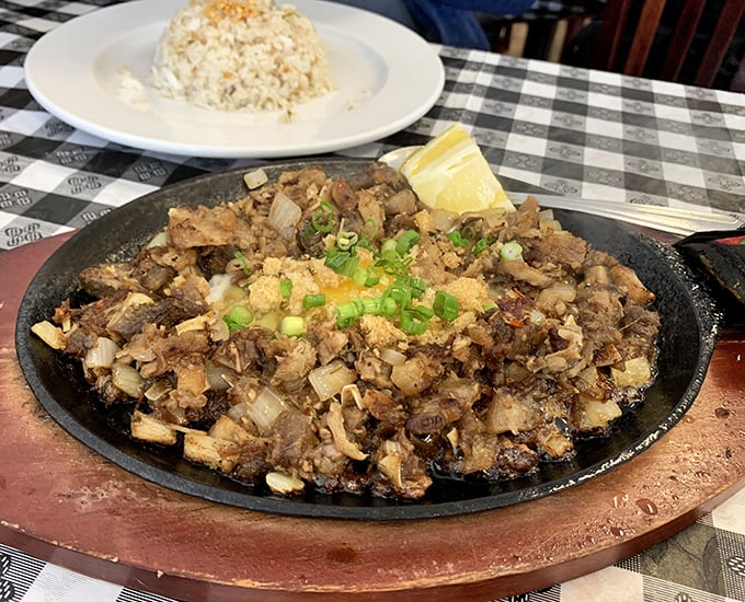 Sizzling sisig&mdash;where chopped pork parts meet a hot skillet and create the kind of symphony that would make Mozart put down his fork and applaud.