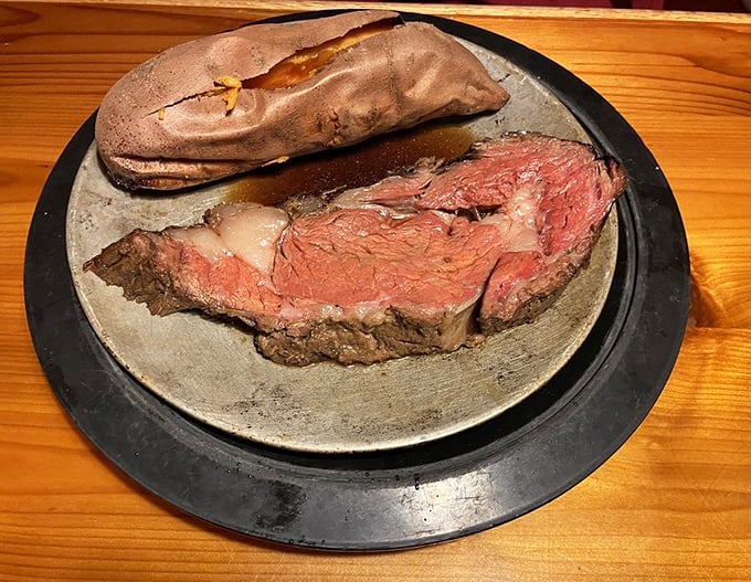 Prime rib so perfectly pink it could make a vegetarian question their life choices. The baked potato stands by, a loyal sidekick.