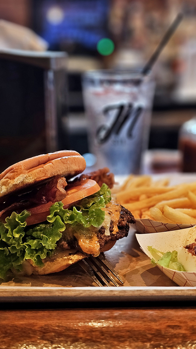 Where burger meets art: melted cheese cascading over a perfectly seared patty, nestled between toasted bun halves. This isn't fast food; it's slow-motion satisfaction.