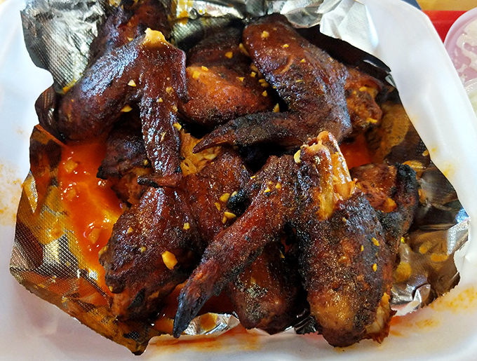 Wings that look like they've earned PhDs in smokology&mdash;crispy, glistening, and unapologetically sauced in what can only be described as liquid happiness.