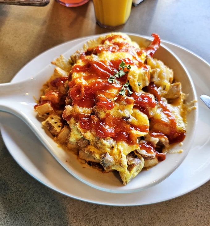 Breakfast architecture at its finest&mdash;layers of eggs, potatoes, and ketchup creating a savory skyscraper that would make Frank Gehry jealous.