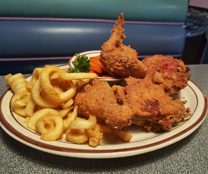 Golden-fried chicken that would make Colonel Sanders question his life choices, served with curly fries that put regular fries to shame.