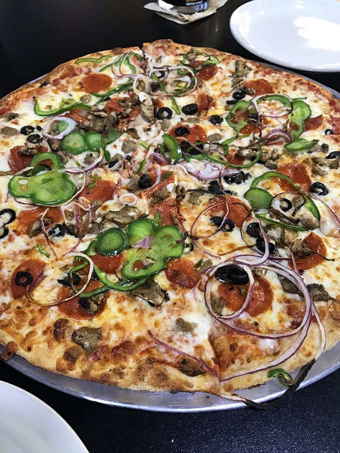 Pizza perfection with toppings that don't know when to quit. Green peppers, red onions, and olives create a garden of earthly delights atop melted cheese.