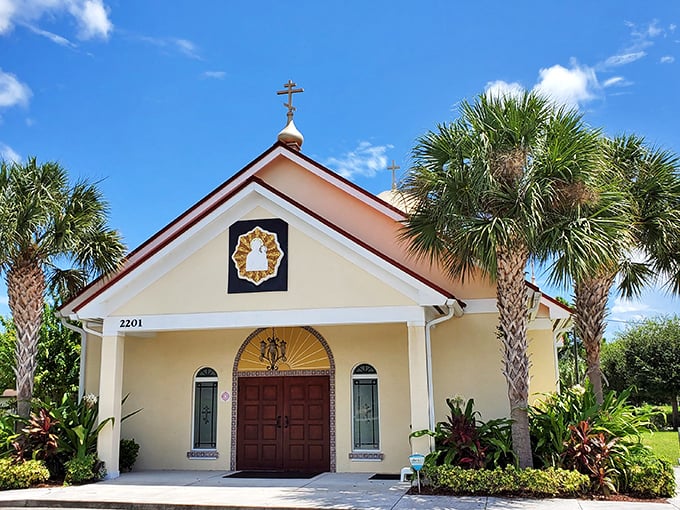 St. James Orthodox Church blends Florida's tropical landscape with timeless architecture. The warm yellow exterior and welcoming entrance create a spiritual oasis surrounded by swaying palms.