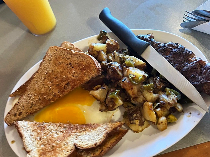 Morning masterpiece: toast perfectly browned, eggs with yolks ready to burst, and home fries that could make a potato farmer weep with pride.