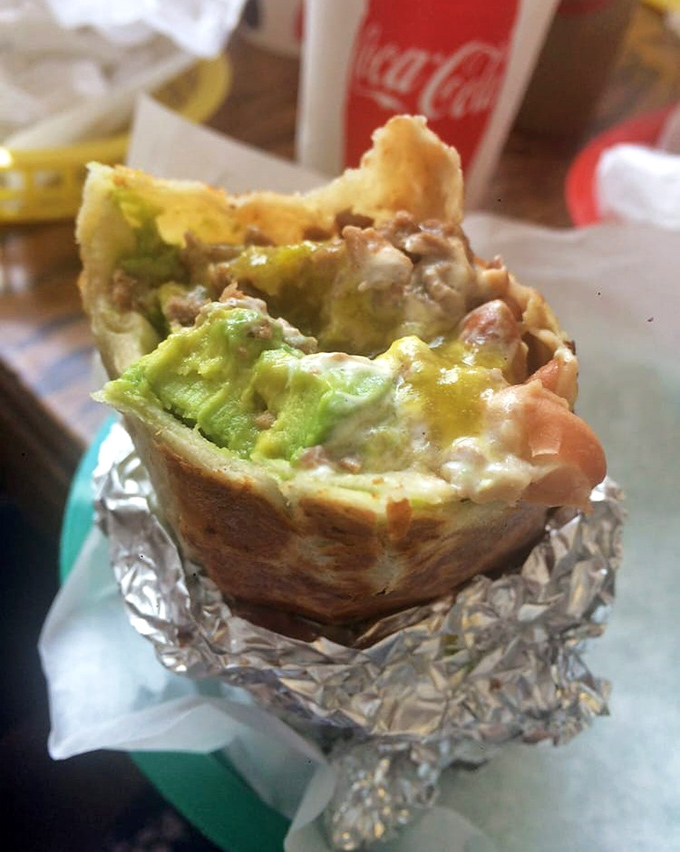 This foil-wrapped burrito bursts with beans, rice, and meat like a delicious edible present.