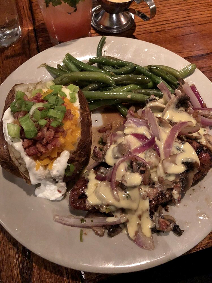 Steak Neil brings the drama with mushrooms, onions, and melted cheese creating a flavor symphony. That loaded baked potato deserves its own fan club. 