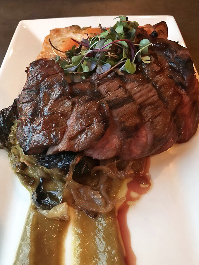 A perfectly seared steak resting on caramelized onions&mdash;proof that sometimes the simplest combinations create the most profound flavors. Meat poetry on a plate.