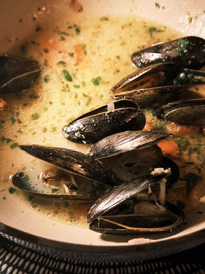 These mussels aren't just swimming in broth; they're luxuriating in a fragrant spa of herbs and wine that you'll want to bottle as cologne.