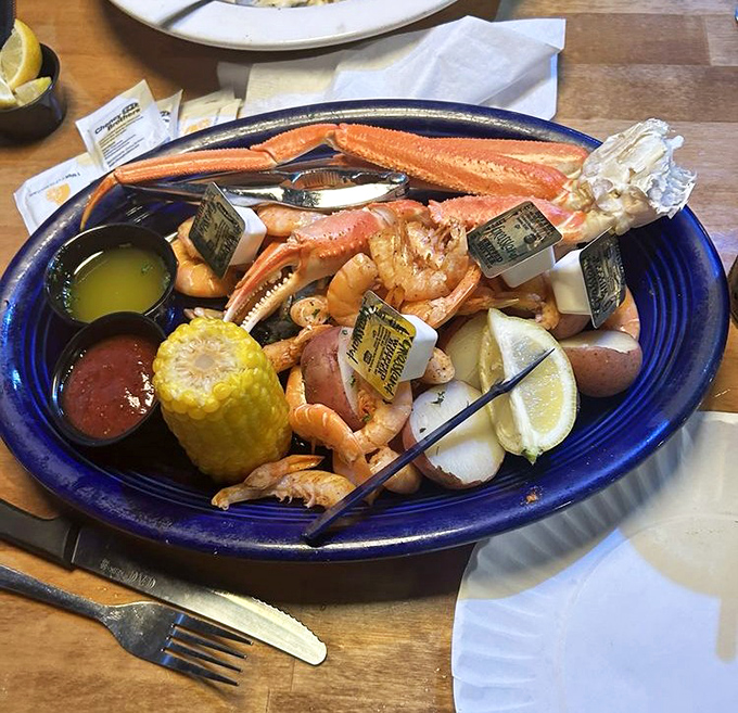 The seafood platter that launched a thousand road trips. Snow crab legs and shrimp playing nicely together on a blue canvas.