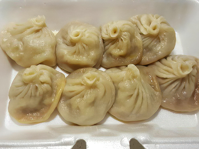 Delicate pleats on these steamed buns showcase the handiwork of skilled dumpling artisans, each fold a testament to tradition and technique.