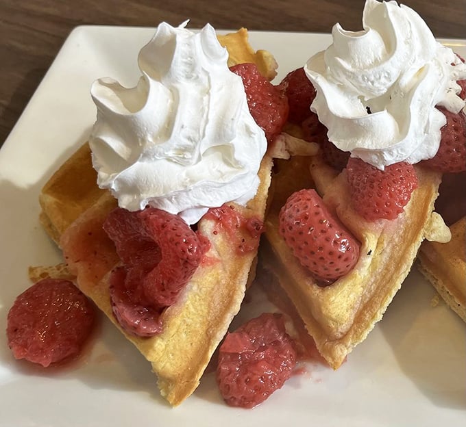 Golden waffles playing host to fresh strawberries and whipped cream &ndash; breakfast's way of saying, "Who needs adulting today?"