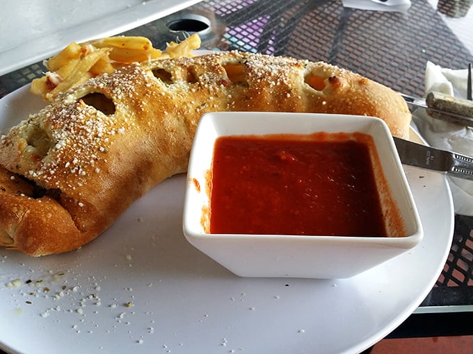 The stromboli – pizza's sophisticated cousin who studied abroad. That golden crust is hiding treasures that make the dipping sauce almost unnecessary. Almost.