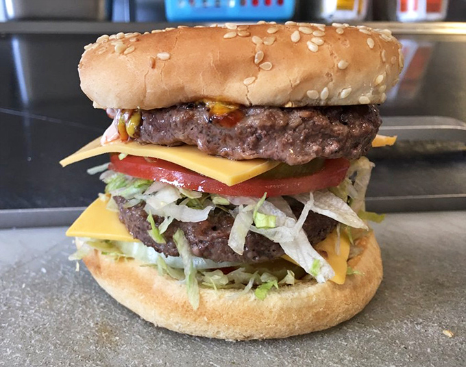 Behold the Super Cheeseburger in all its glory—where the cheese doesn't just melt, it performs a slow, sensuous dance across the patties.