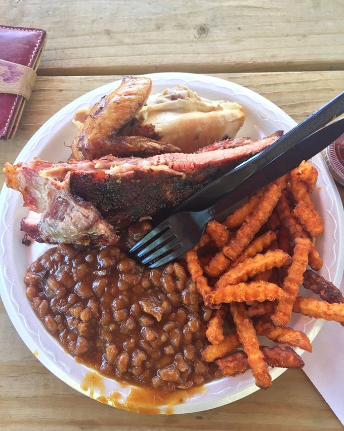 Ribs that would make Fred Flintstone jealous, served with baked beans that have clearly been simmering since the Carter administration and sweet potato fries crispy enough to make you weep.