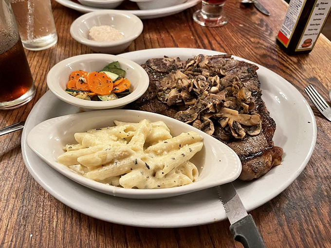 The T-bone arrives like a meaty masterpiece, topped with mushrooms that have clearly found their purpose in life&mdash;making this steak even more magnificent.