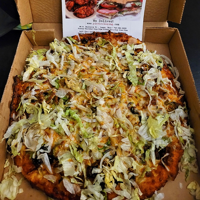 The Mexican Pizza comes dressed for a fiesta, with fresh lettuce creating a crisp, cool contrast to the savory layers beneath – like a taco and pizza had a delicious love child.