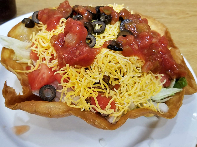 A taco salad that doesn't understand the meaning of "portion control." That crispy shell is basically an edible bowl designed for maximum filling capacity.