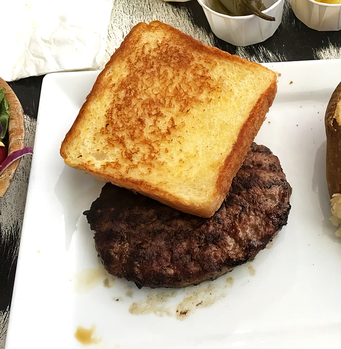 Texas toast: where bread transcends its humble origins and becomes the perfect tool for sopping up those precious meat juices.