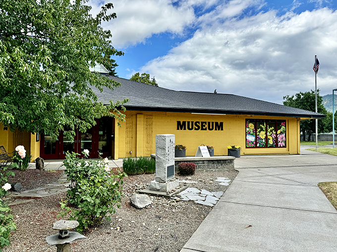 The sunny yellow History Museum stands like a cheerful librarian, ready to share stories of Hood River's past with anyone who stops by.