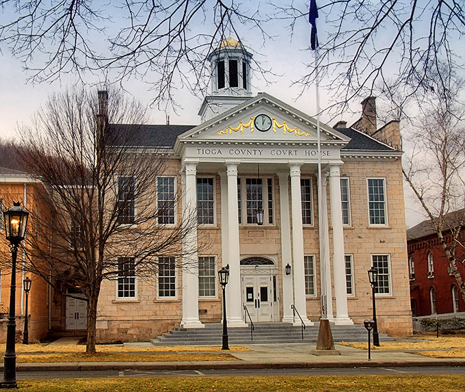 The Tioga County Courthouse stands as a stately reminder that small-town architecture once prioritized beauty alongside function, with columns that wouldn't look out of place in Washington.