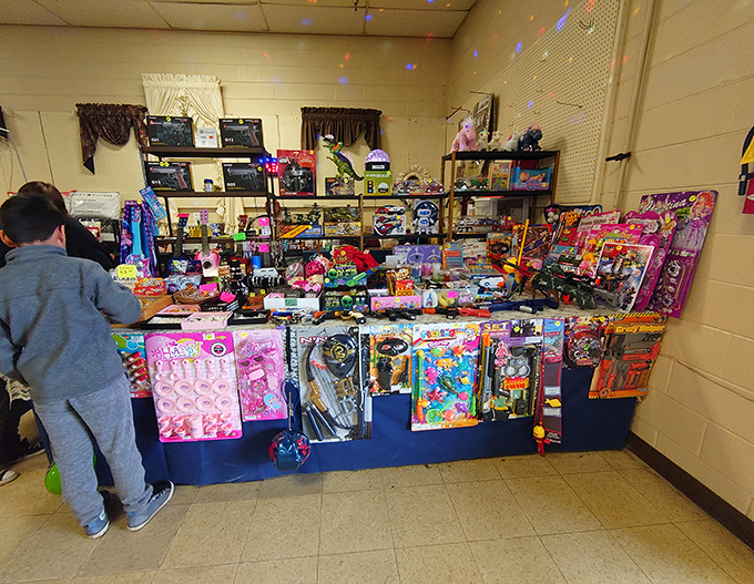 Childhood joy by the tableful! A young shopper contemplates which colorful toy might become tomorrow's favorite playmate.