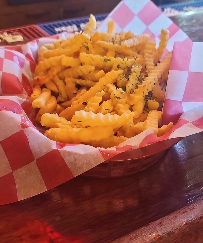 These aren't just fries; they're crispy, golden vehicles for herb-flecked happiness. The kind that make you forget your table manners as you reach for "just one more."