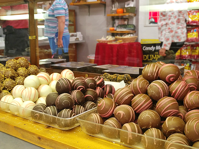 Truffles lined up like edible marbles, each one swirled with artistic precision that seems almost too beautiful to eat. Almost.