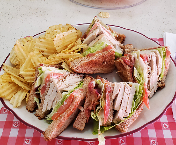 The club sandwich&mdash;architecture you can eat! Layers of fresh turkey, crisp vegetables, and toast stacked higher than your weekend plans.