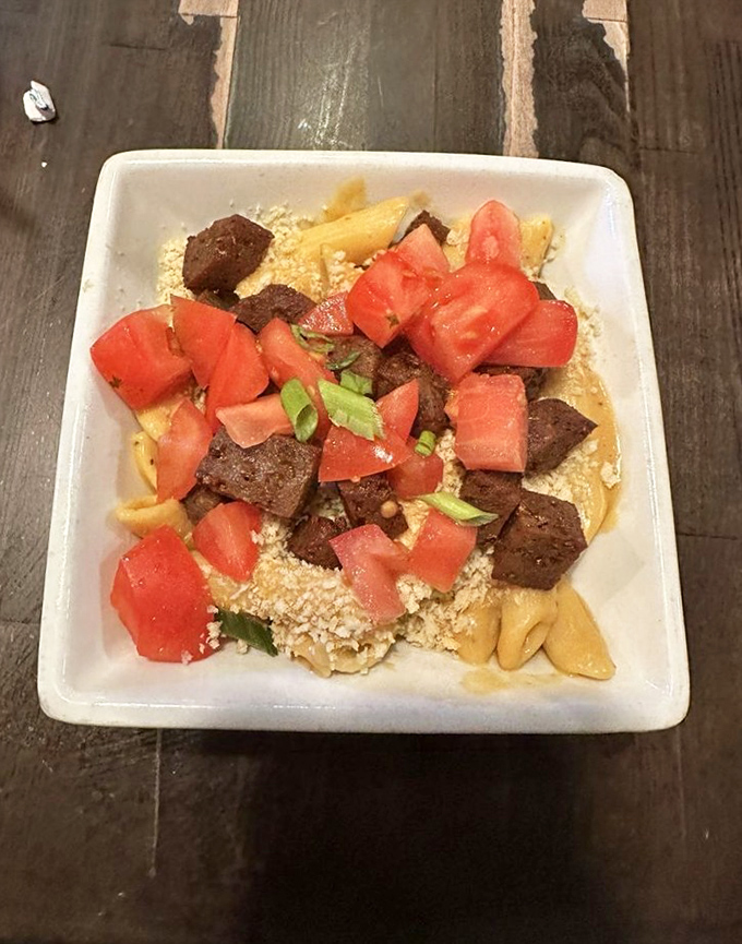 Vegan mac and cheese that doesn't taste like compromise. Those fresh tomatoes add a pop of color and flavor that says "who needs dairy?"