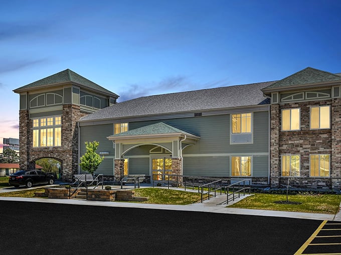 Modern retirement living meets small-town charm in these welcoming apartments. The warm glow from windows promises comfort after a day of Wapakoneta adventures.