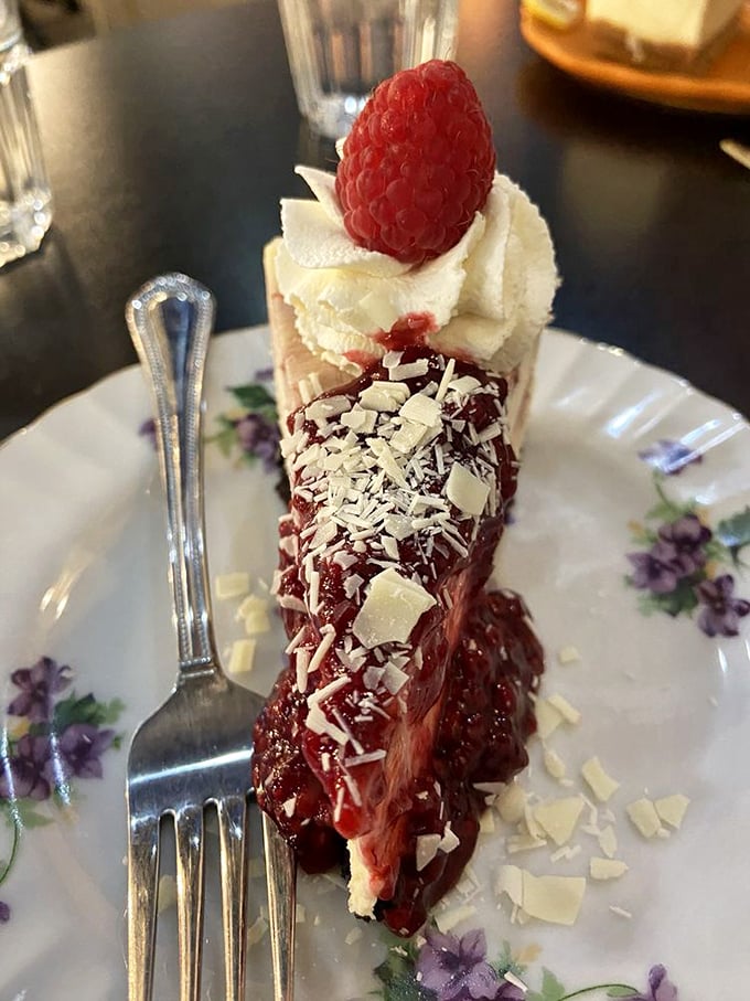 A raspberry crowns this slice like royalty, while white chocolate shavings add texture to what might be the most photogenic dessert in Oregon.