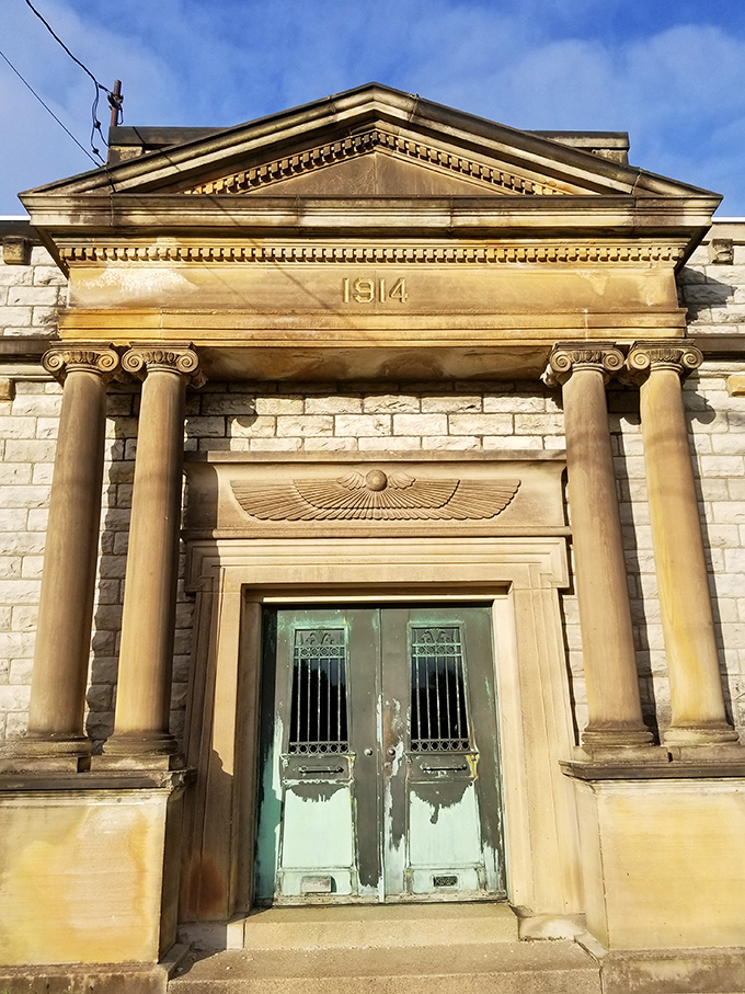 Classical columns and weathered doors mark this 1914 mausoleum, a dignified reminder of history's permanence in an increasingly temporary world.