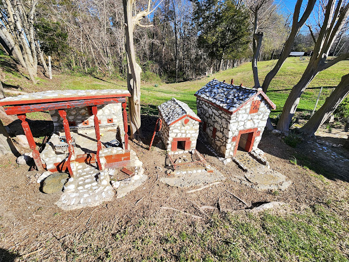 Two tiny outbuildings connected by what might be the world's smallest covered bridge. Even the Keebler elves would consider this a luxury estate. 