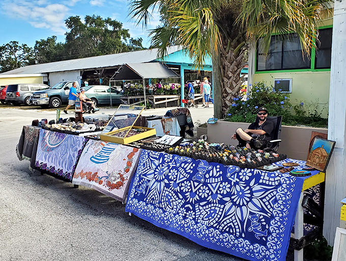 A splash of vibrant blue fabric transforms ordinary tables into an island of potential discoveries waiting for the right pair of eyes.