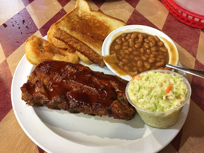 Ribs that don't need a sales pitch. That glistening sauce, tender meat, and the sides playing perfect supporting roles tell the whole delicious story.
