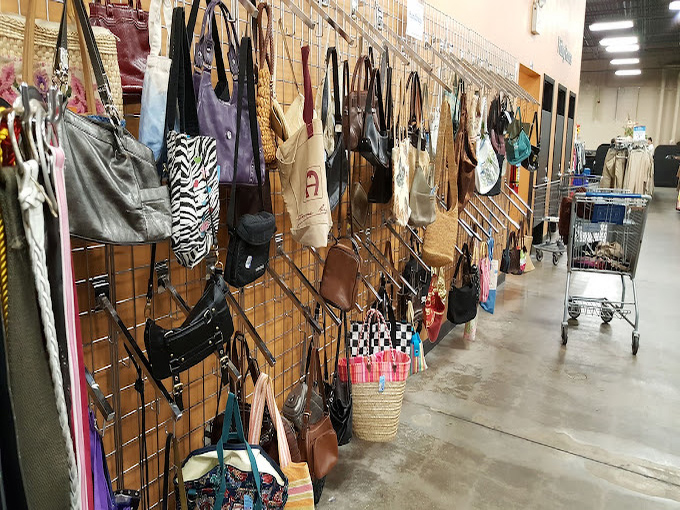 Handbag heaven! Designer dreams and practical purses hanging side by side like old friends at a reunion, each with stories to tell.