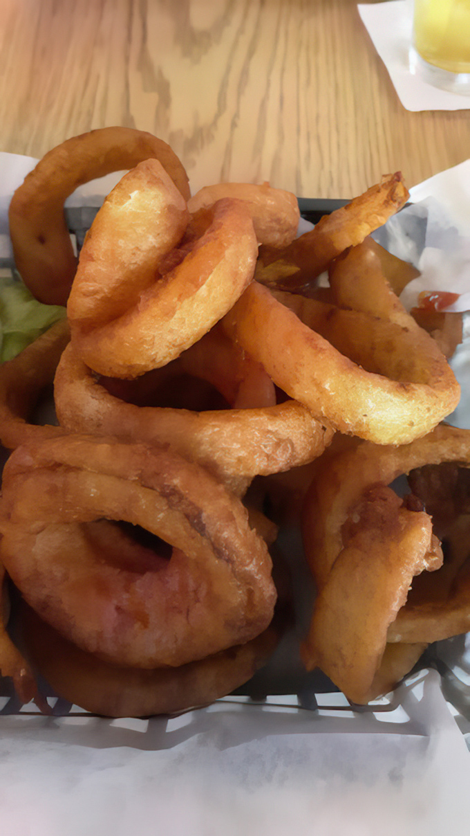 Onion rings that shatter with satisfying crispness, revealing sweet onion centers&mdash;the kind that make you forget your table manners as you reach for another.
