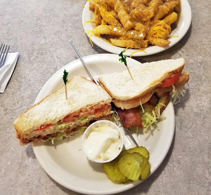 A perfectly executed sandwich with crisp bacon and fresh tomato, served with those legendary gravy cheese fries. Comfort food nirvana achieved.