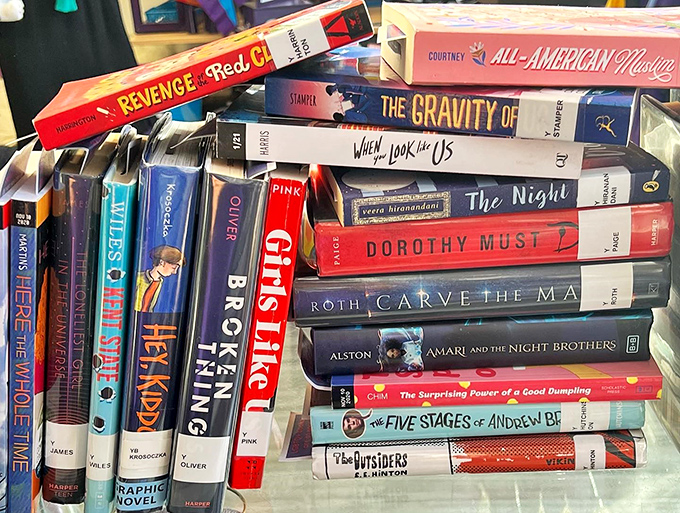 Literary treasures line up for adoption. From graphic novels to bestsellers, these gently-loved books are ready for their next chapter in your home library.