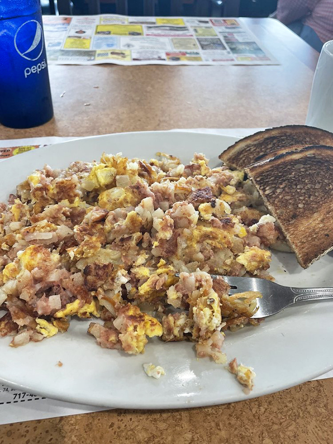 Breakfast alchemy at its finest: eggs, potatoes, and meat joining forces with toast to create the fuel that powers Pennsylvania's workday heroes.