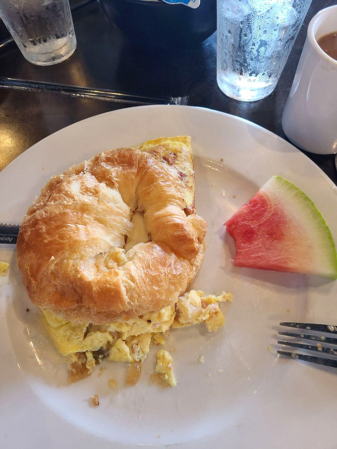 The breakfast sandwich that launched a thousand road trips. Flaky croissant, fluffy eggs, and a slice of watermelon playing the refreshing sidekick.